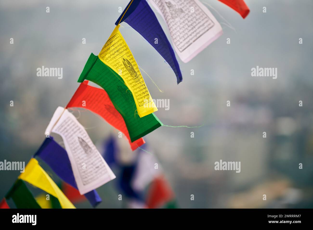 Colorful Tibetan prayer flags on blurred Kathmandu cityscape background ...