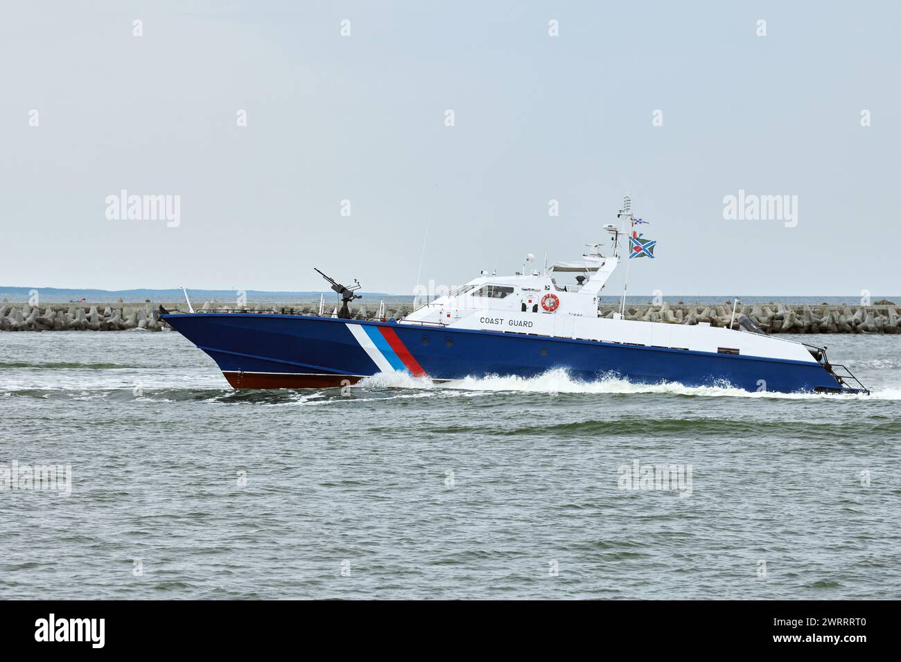 Coast guard ship sails along seaside for safeguarding coastal ...