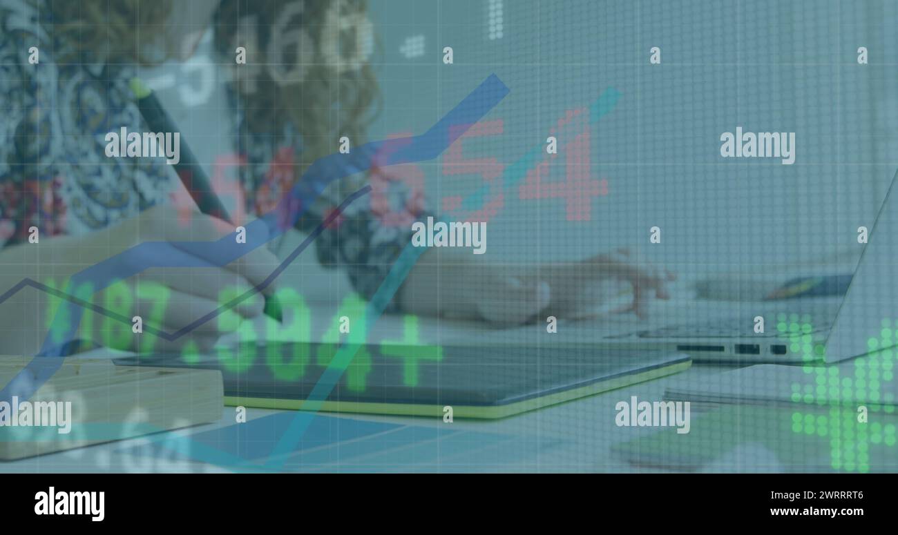 Image of financial data processing over woman in office using graphic tablet Stock Photo - Alamy