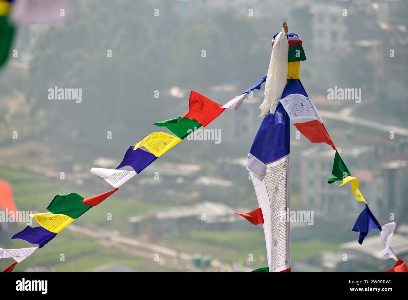 Colorful Tibetan prayer flags on blurred Kathmandu cityscape background ...