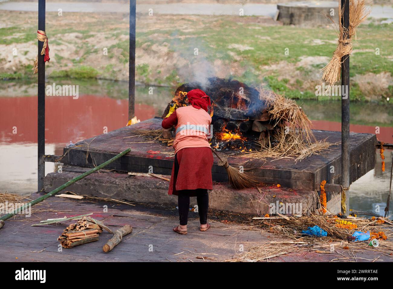 Staff employee of Pashupatinath Temple complex overseeing for funeral ...