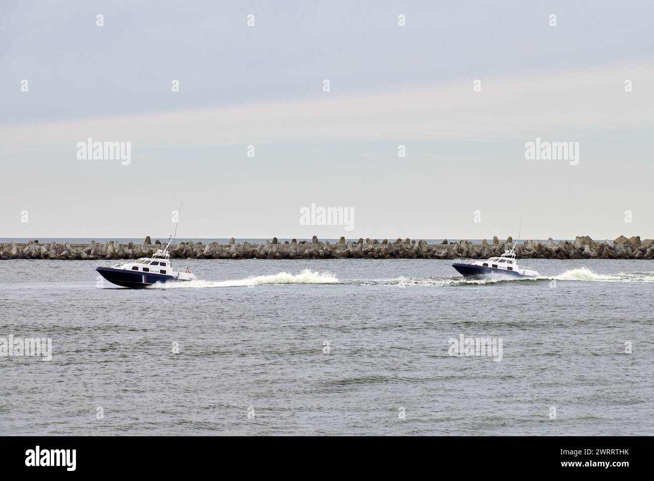 Two coast guard boats sails along seaside for safeguarding coastal ...