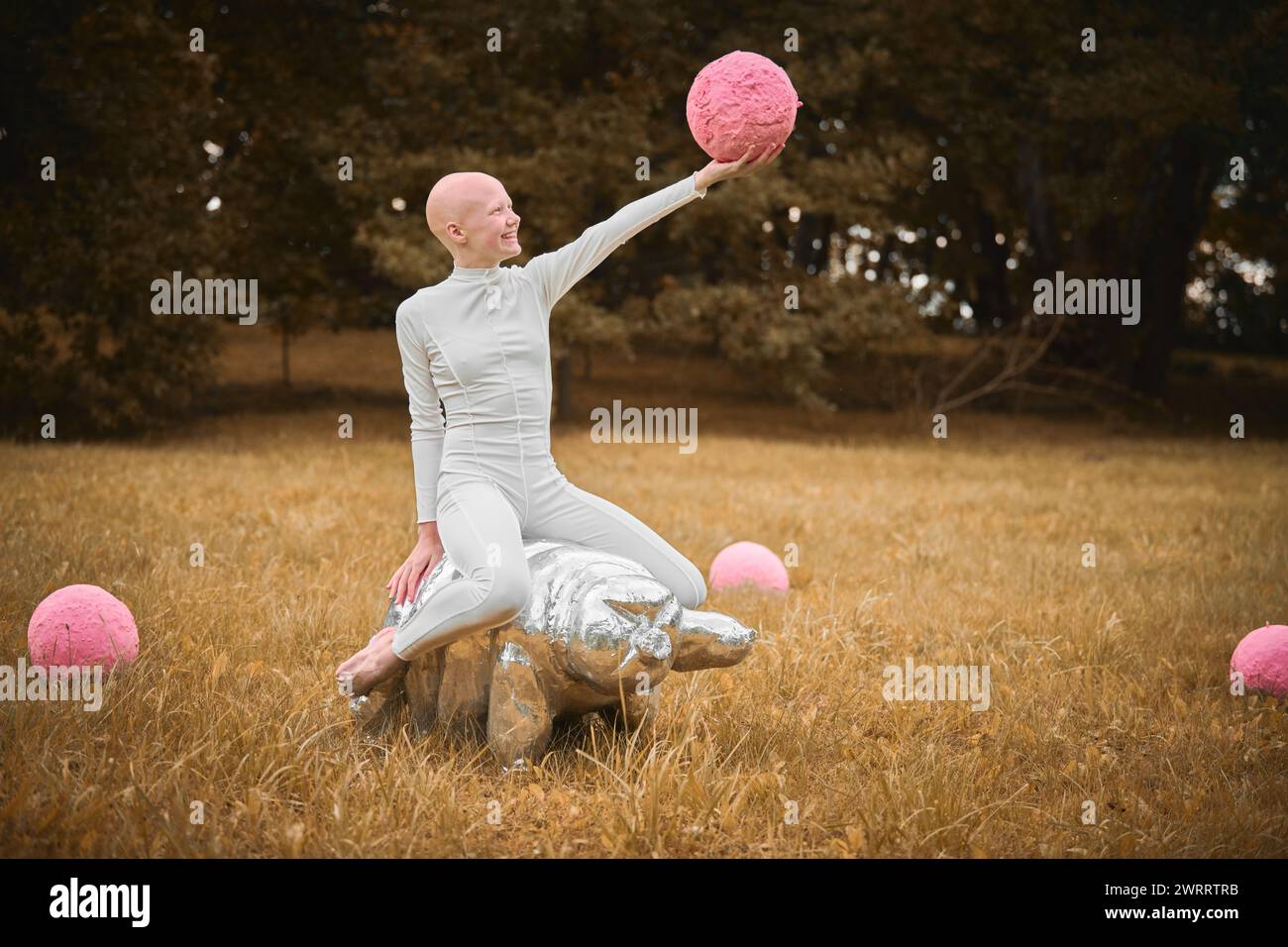 Young hairless girl with alopecia in white cloth sits on tardigrade ...