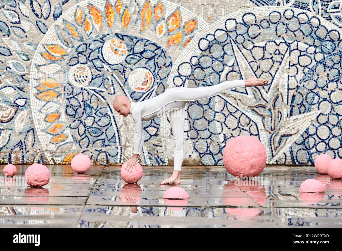 Outdoor dance of young ballerina girl with alopecia in white futuristic ...