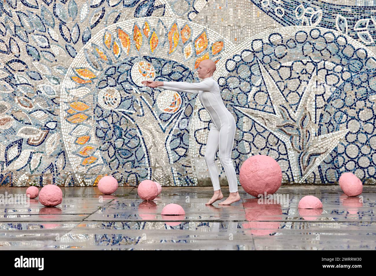 Young hairless girl ballerina with alopecia in white futuristic suit ...