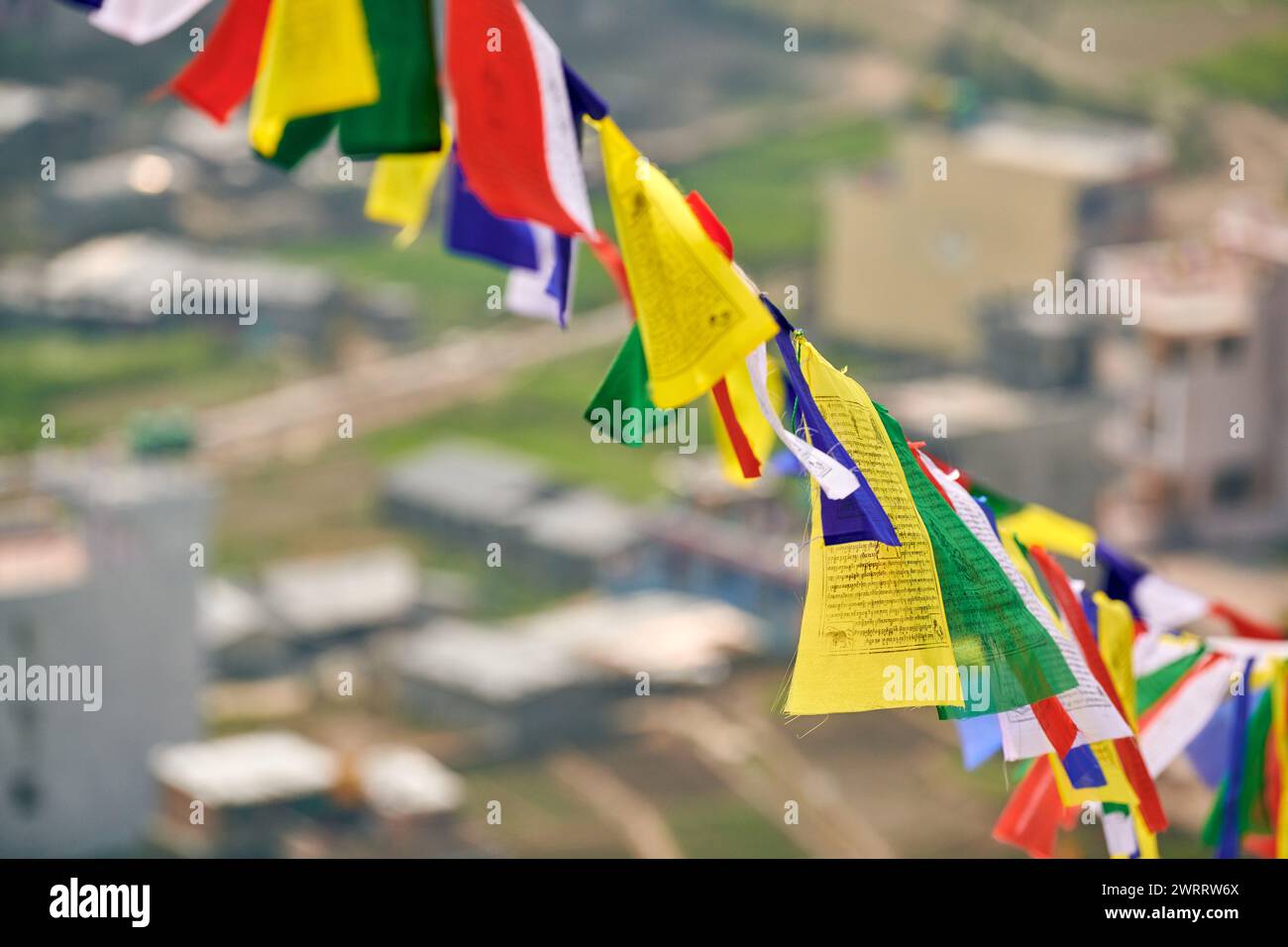 Colorful Tibetan prayer flags on blurred Kathmandu cityscape background ...