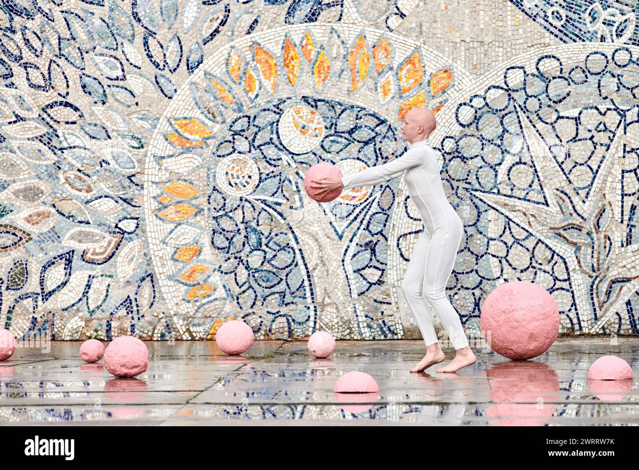Young hairless girl ballerina with alopecia in white futuristic suit ...