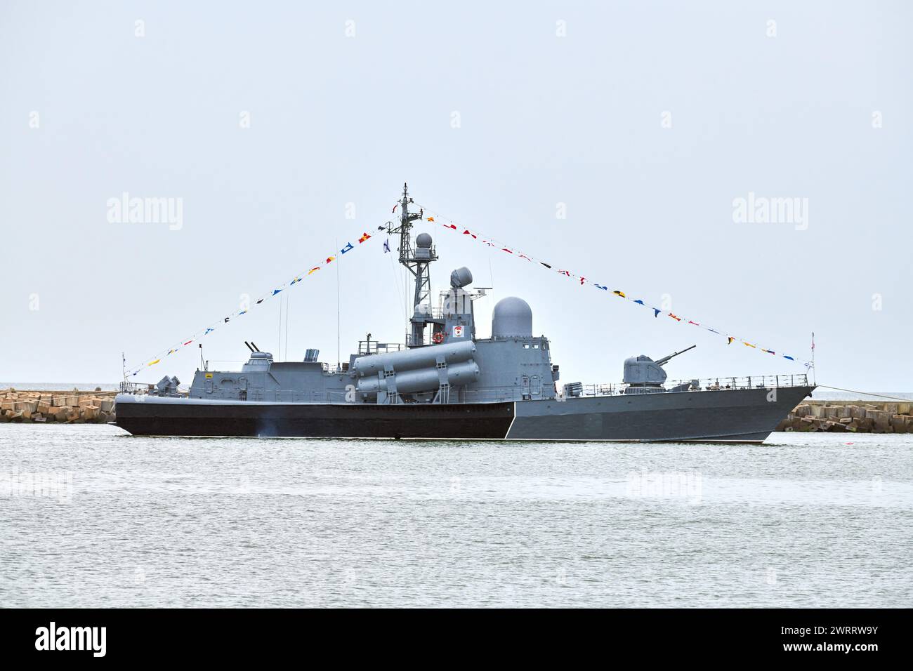 Russian naval ship with signal nautical flags anchored along shoreline ...