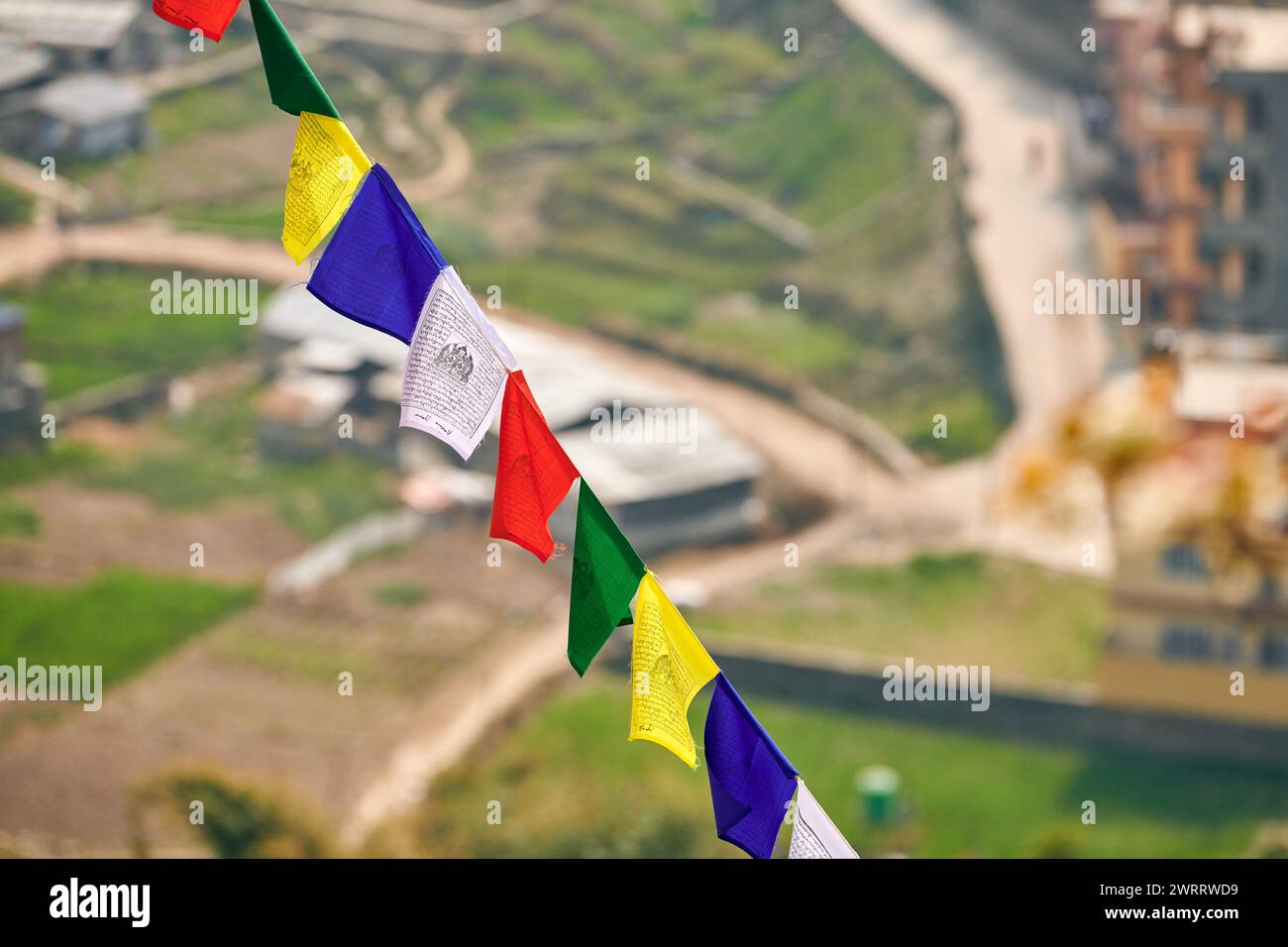 Colorful Tibetan prayer flags on blurred Kathmandu cityscape background ...