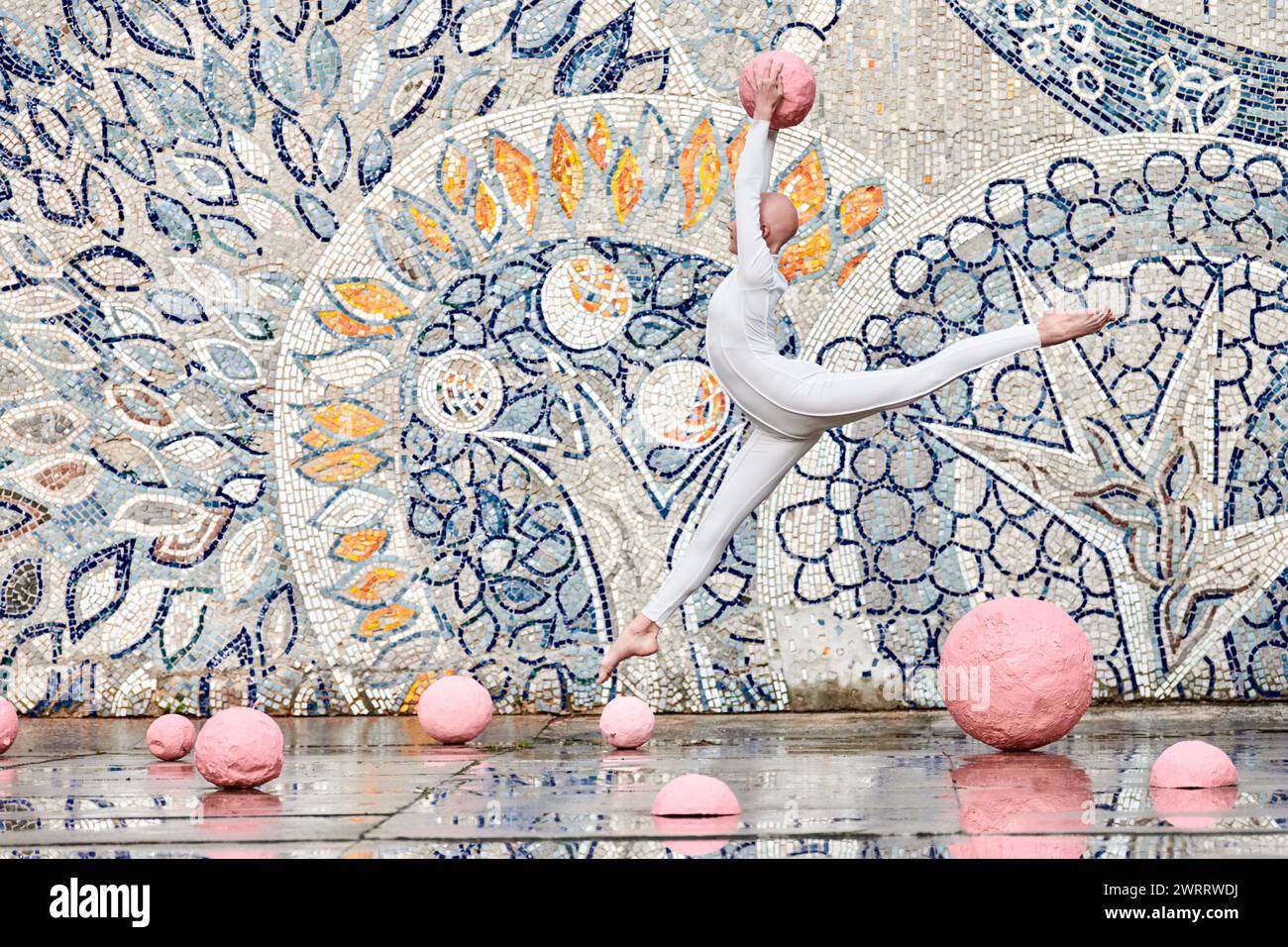 Young hairless girl ballerina with alopecia in white futuristic suit ...