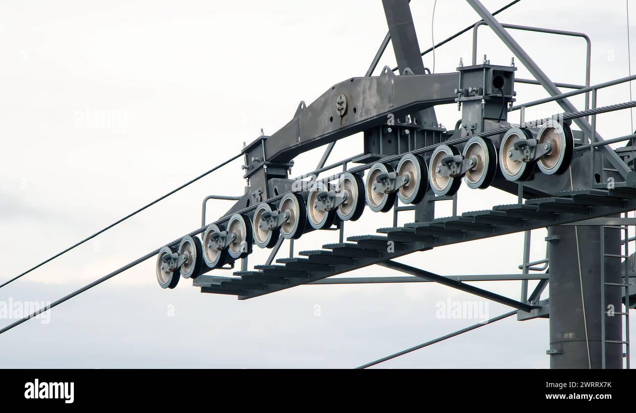 Rolling wheels mechanism of the cableway system. Steel cable high at ...