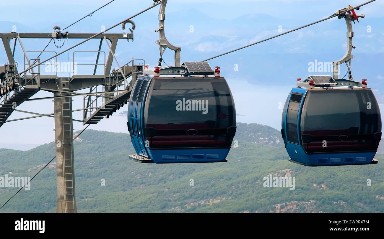 Ropeway, cable car cabins against seascape in Oludeniz, Turkey. Tourism ...