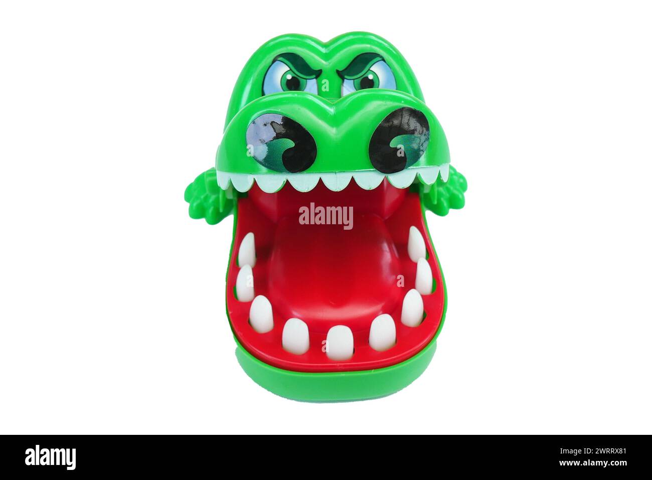 Crocodile bites plastic toy isolated Stock Photo - Alamy