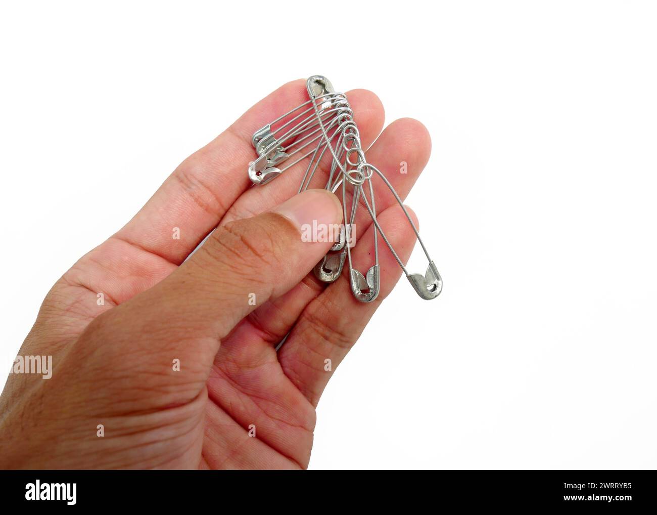 Hand holding many sewing pins isolated on white background Stock Photo ...