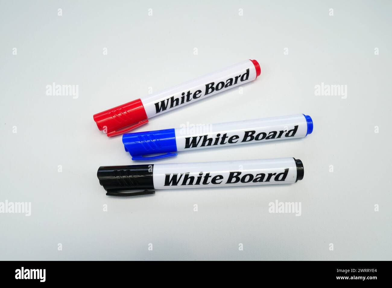 Three color markers, red, black and blue on a white background Stock ...