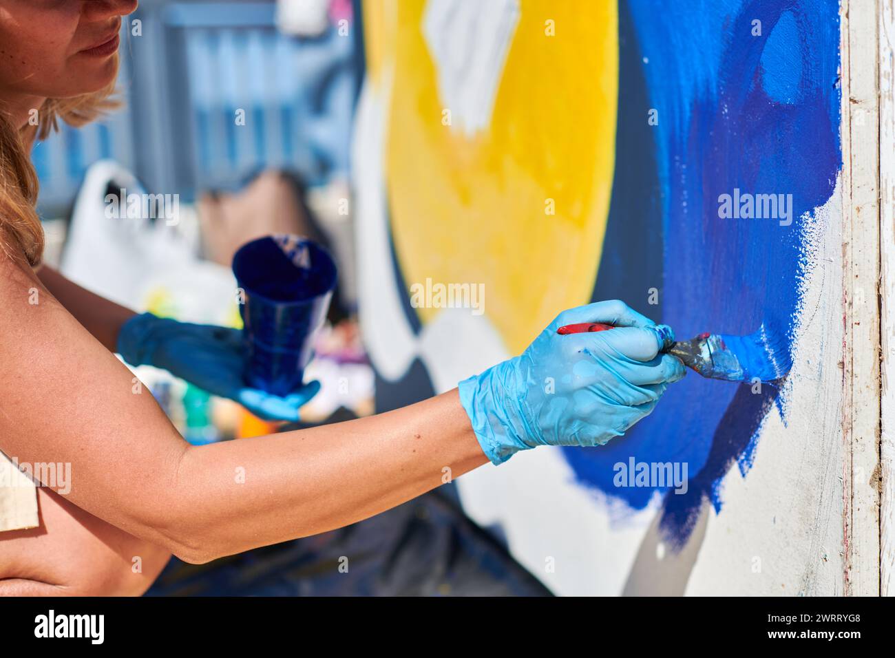 Female painter hand passionately paints picture with paintbrush for ...