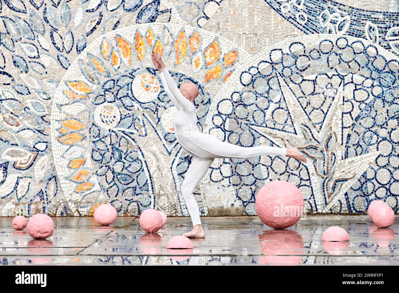 Young hairless girl ballerina with alopecia in white futuristic suit ...