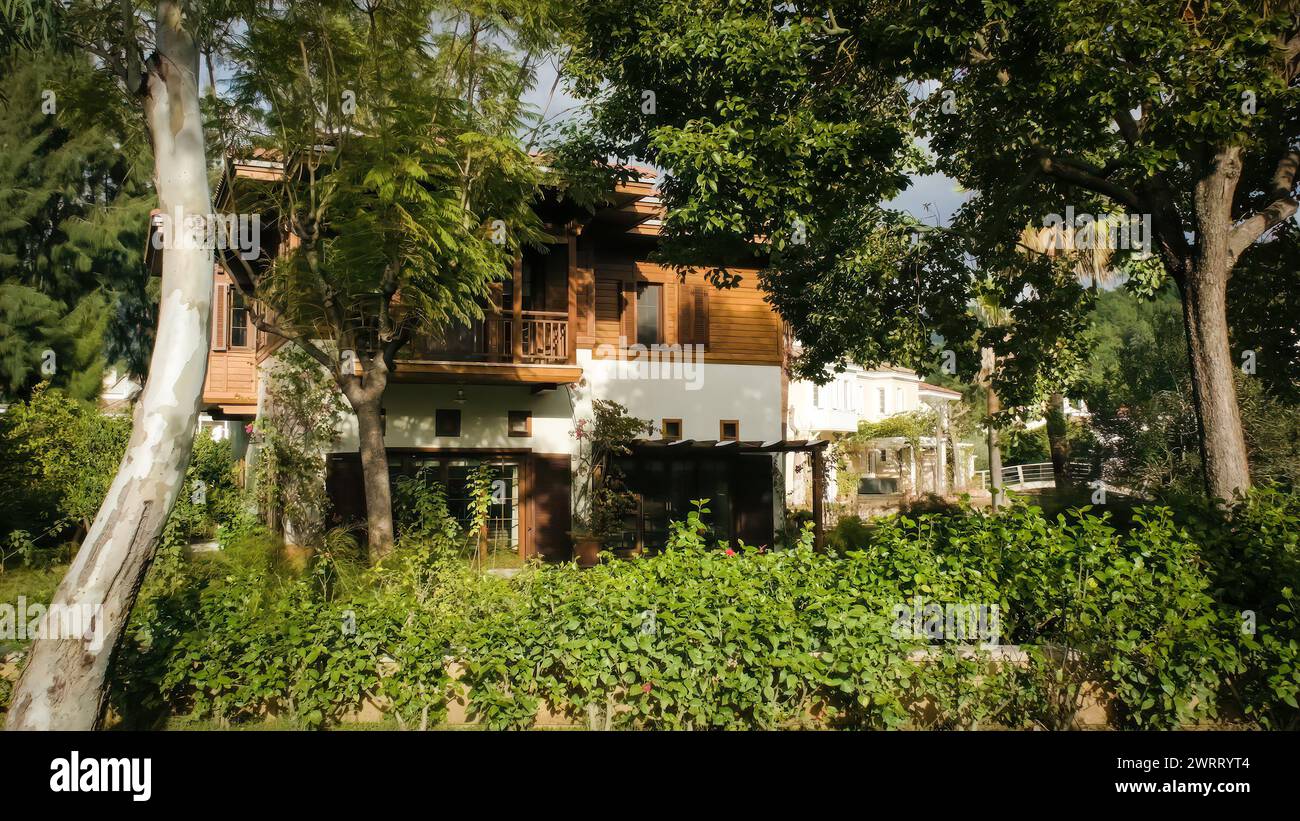 View of new modern residential house cottage hidden among trees and ...