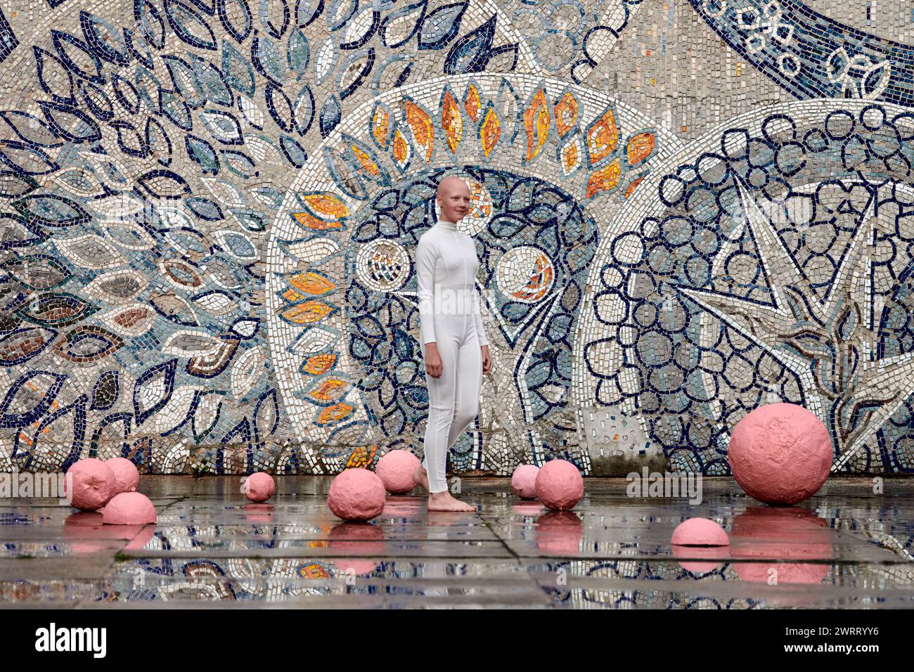Young hairless girl ballerina with alopecia in white futuristic suit ...