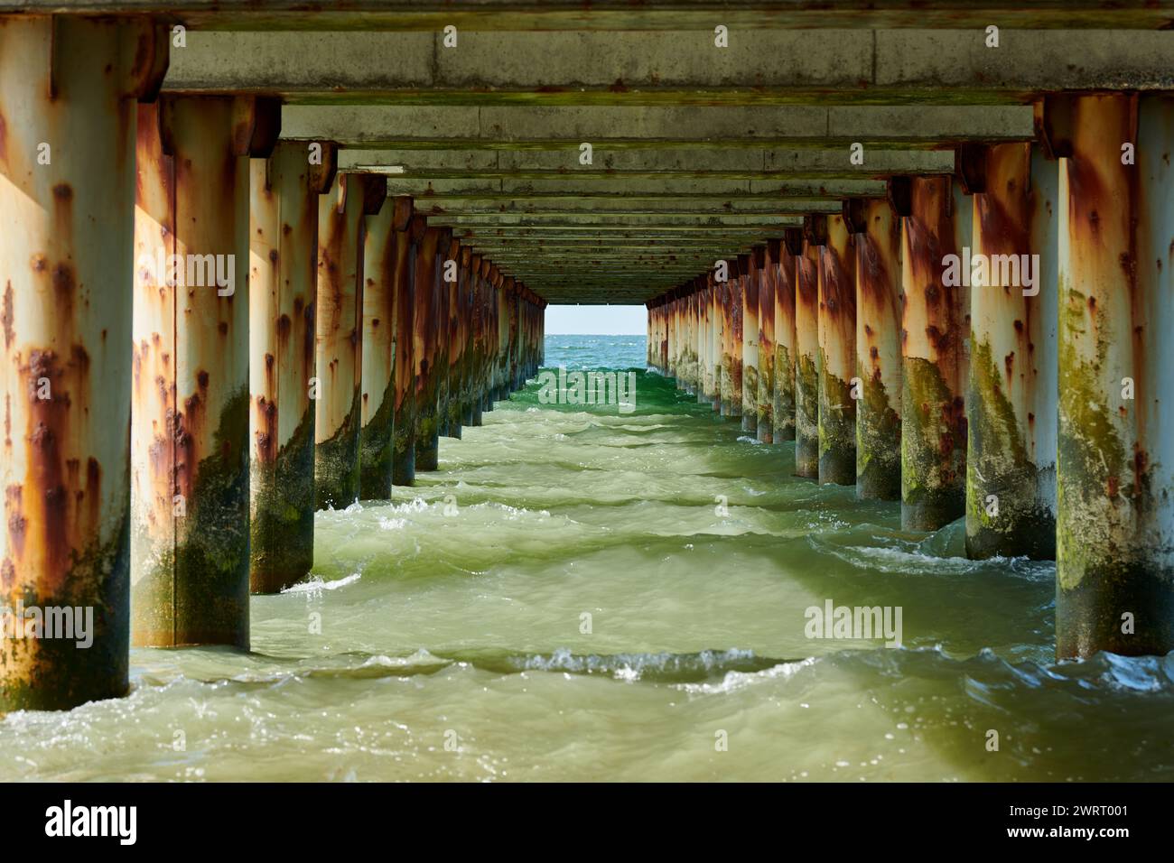 Rusty pillars of old sea pier create mesmerizing seascape scene with ...
