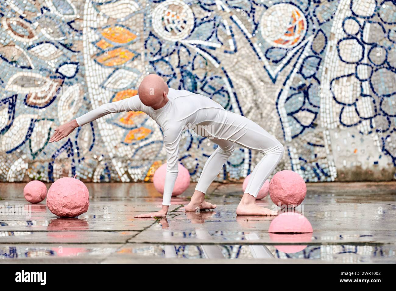 Outdoor dance of young ballerina girl with alopecia in white futuristic ...