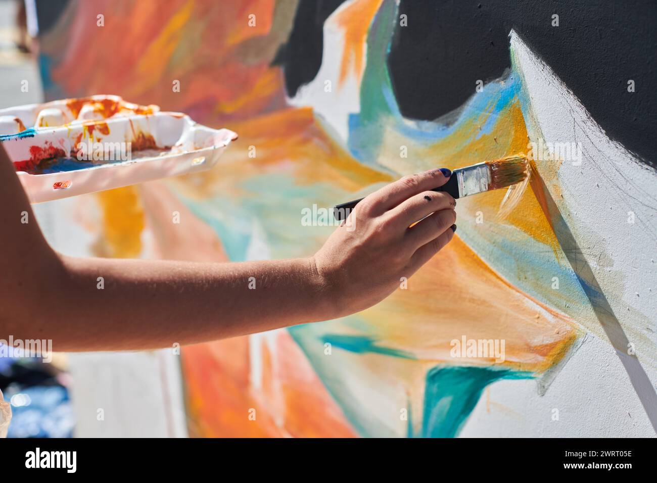 Female painter hand passionately paints picture with paintbrush for ...