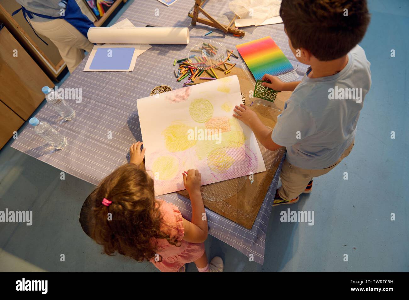 View from above of a teenage school boy and elementary age schoolgirl ...