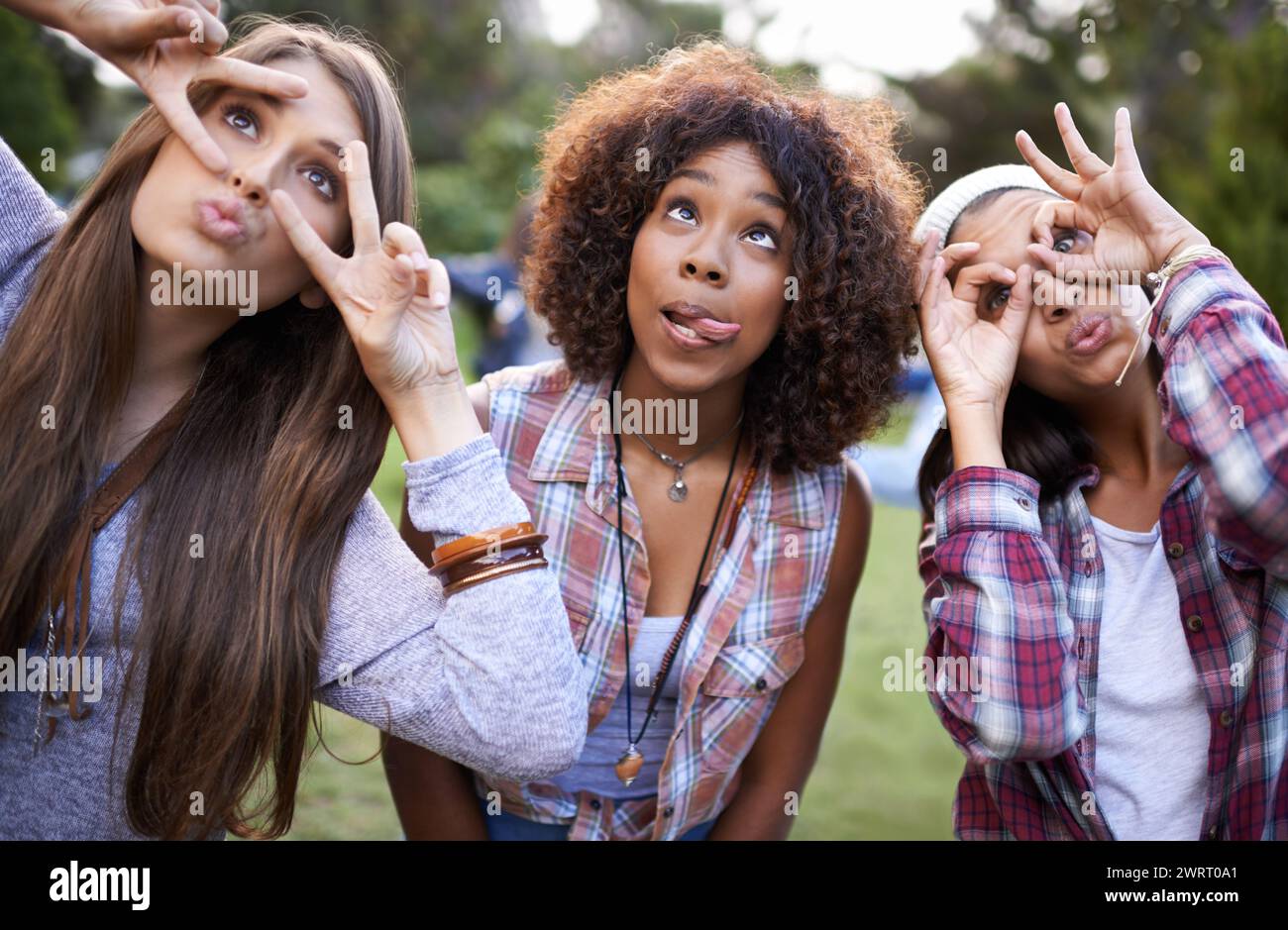 Funny, face and friends in a park with silly, fun or bonding on ...