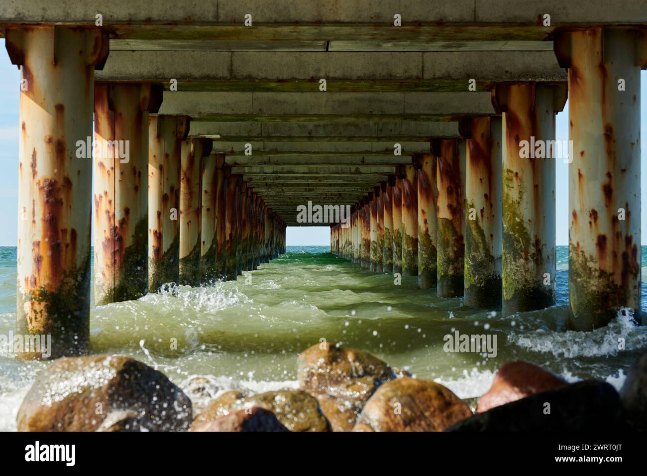 Rusty pillars of old sea pier create mesmerizing seascape scene with ...