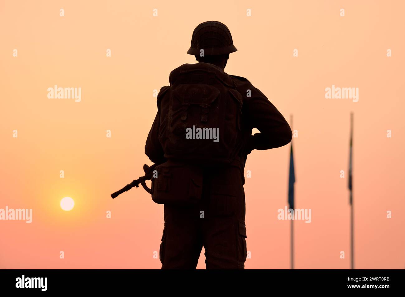 Rear view of silhouette of soldier in military gear holds weapon ...