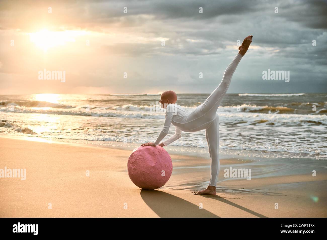 Hairless ballerina with alopecia in white futuristic suit dancing with ...