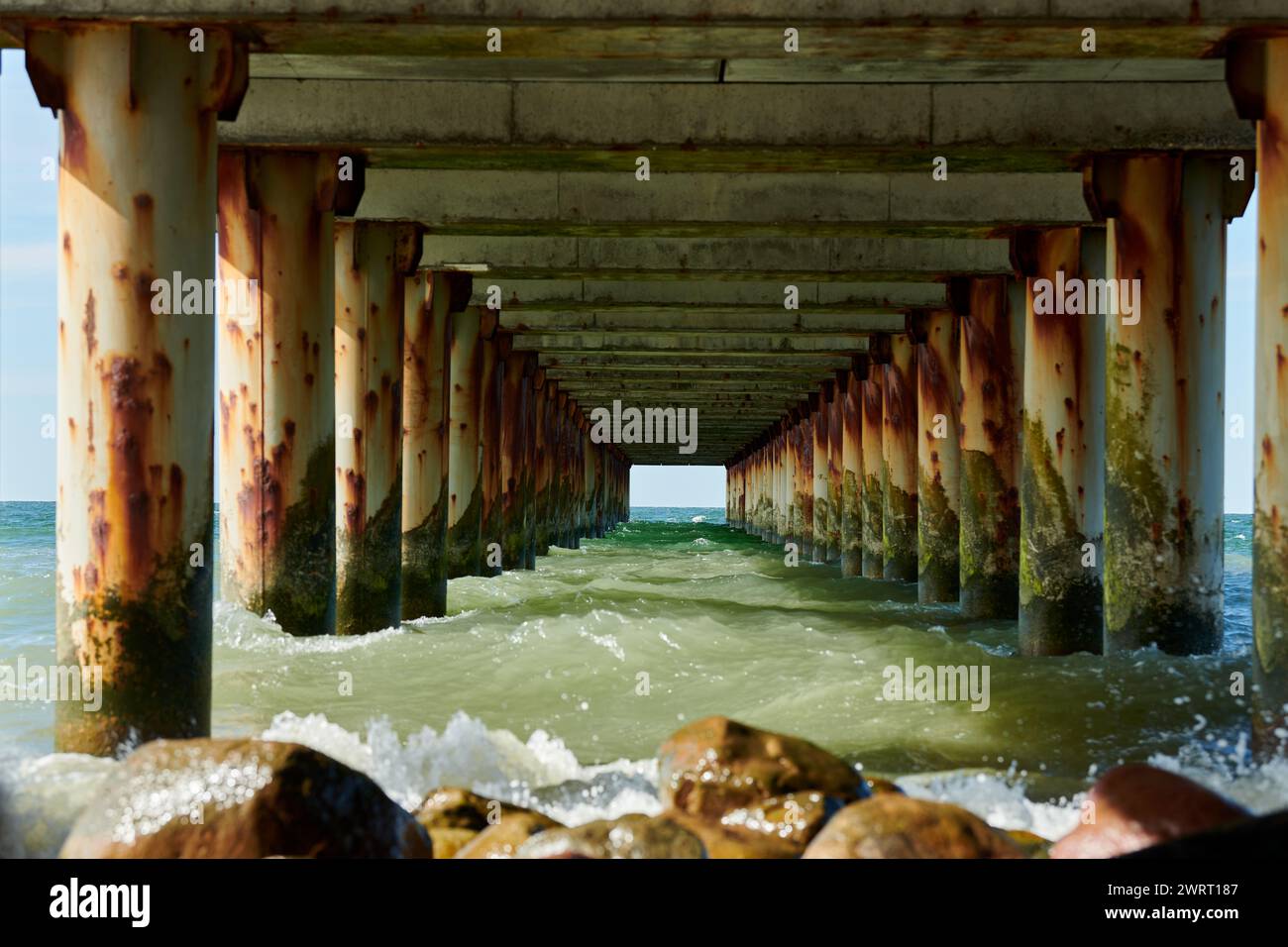 Rusty pillars of old sea pier create mesmerizing seascape scene with ...
