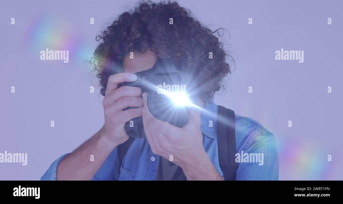 Spot of light against african american male photographer clicking ...