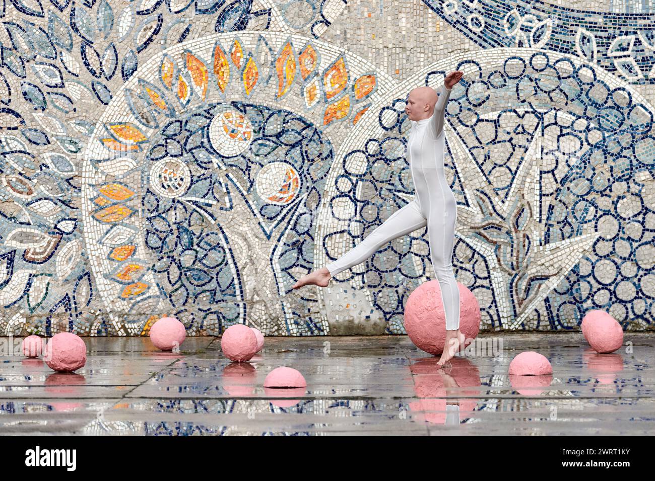 Young hairless girl ballerina with alopecia in white futuristic suit ...