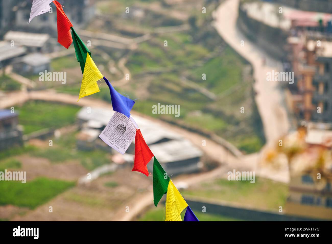 Colorful Tibetan prayer flags on blurred Kathmandu cityscape background ...