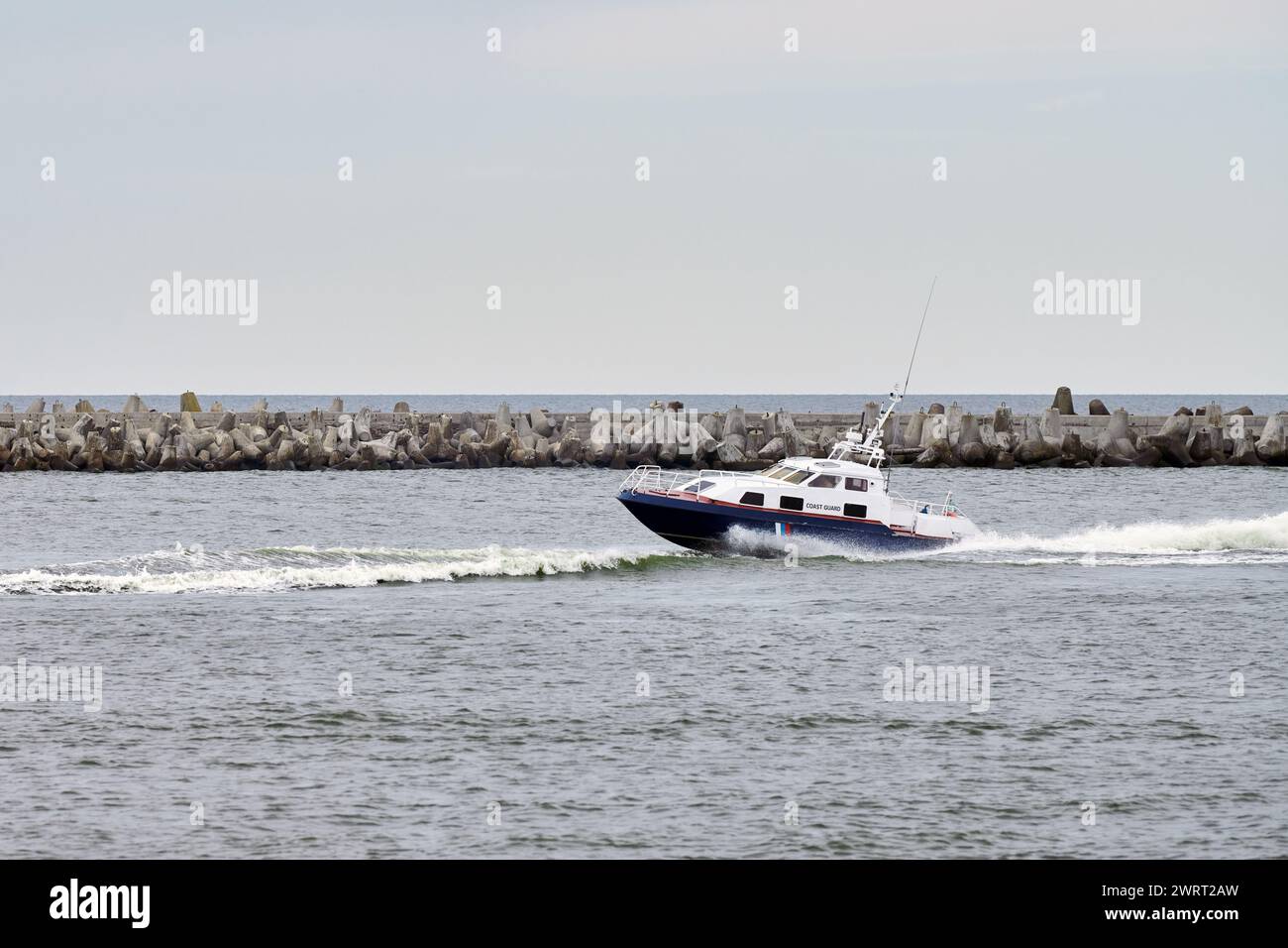 Coast guard boat sails along seaside for safeguarding coastal ...