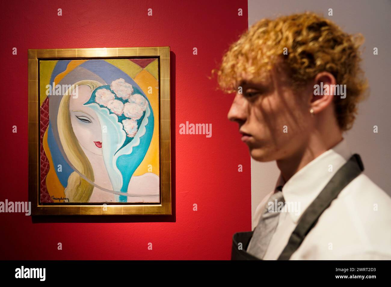A member of staff stands next to the original artwork by E. Frandsen De ...