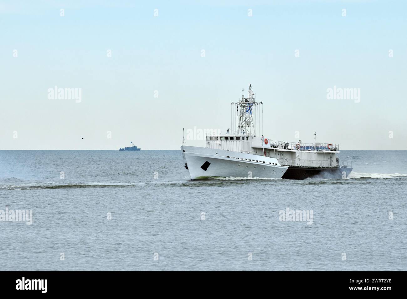 Coast guard ship sails along seaside for safeguarding coastal ...