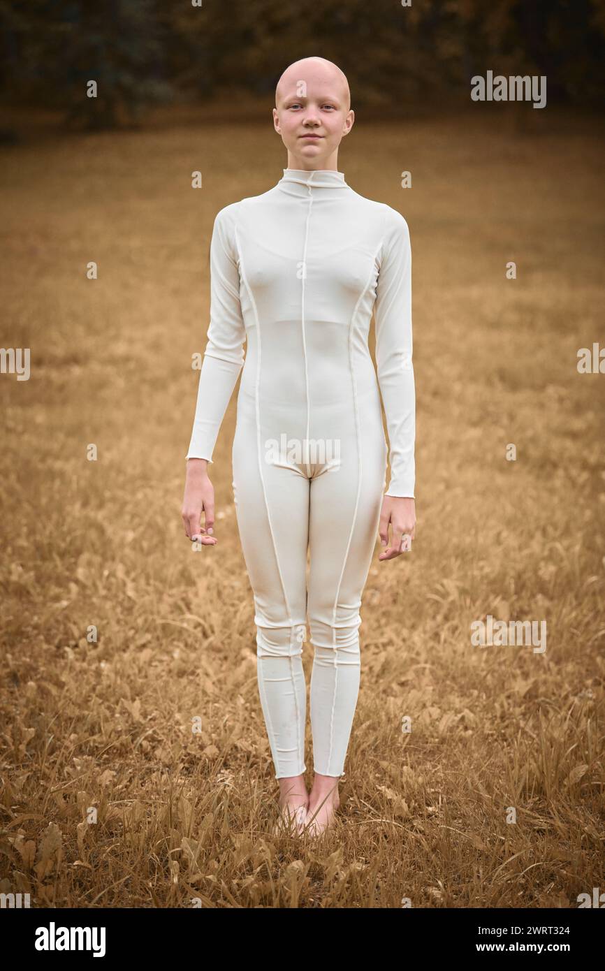 Full length portrait of young hairless girl with alopecia in white ...