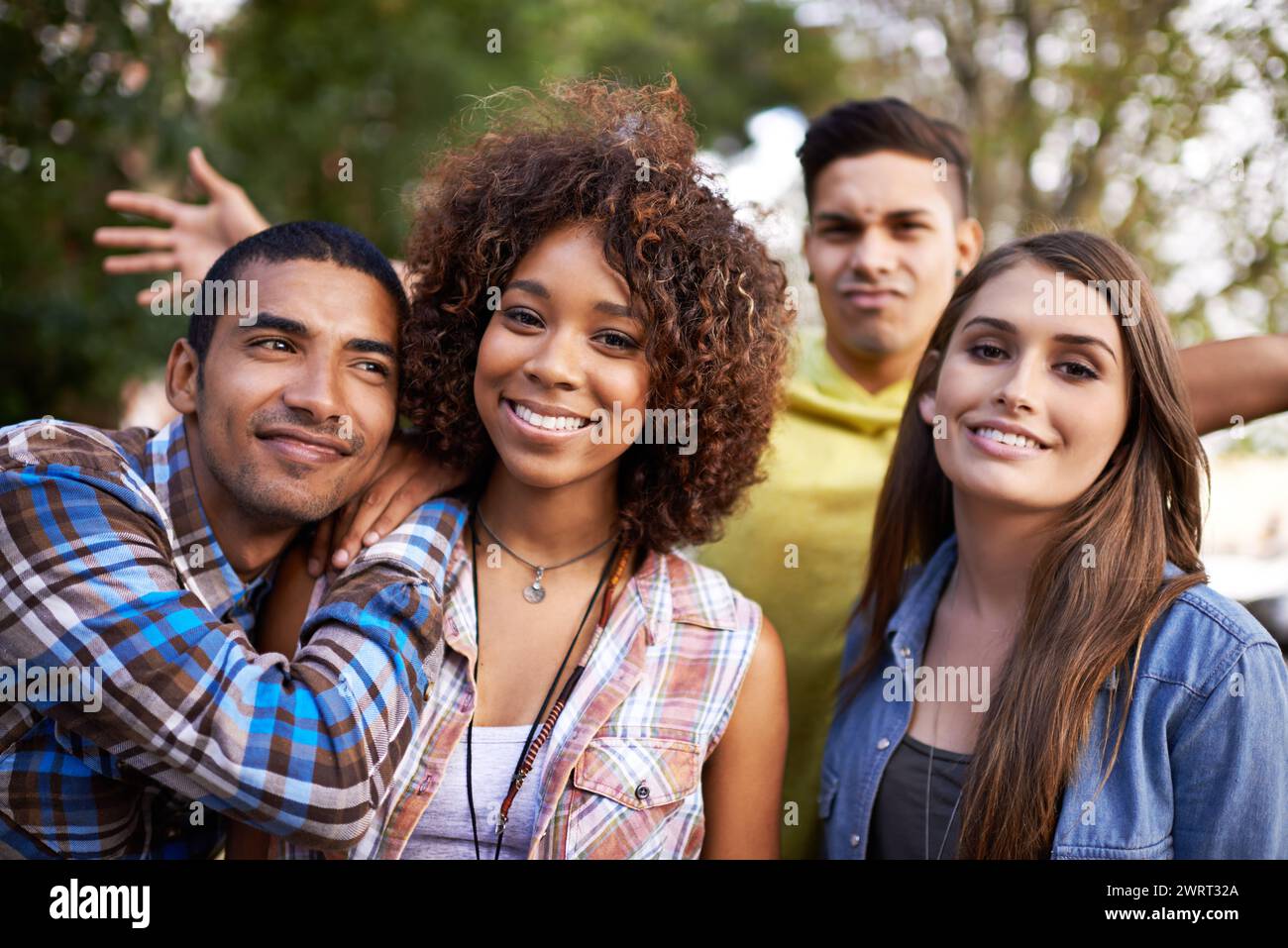 Portrait, smile and group with diversity, sunshine and nature with ...