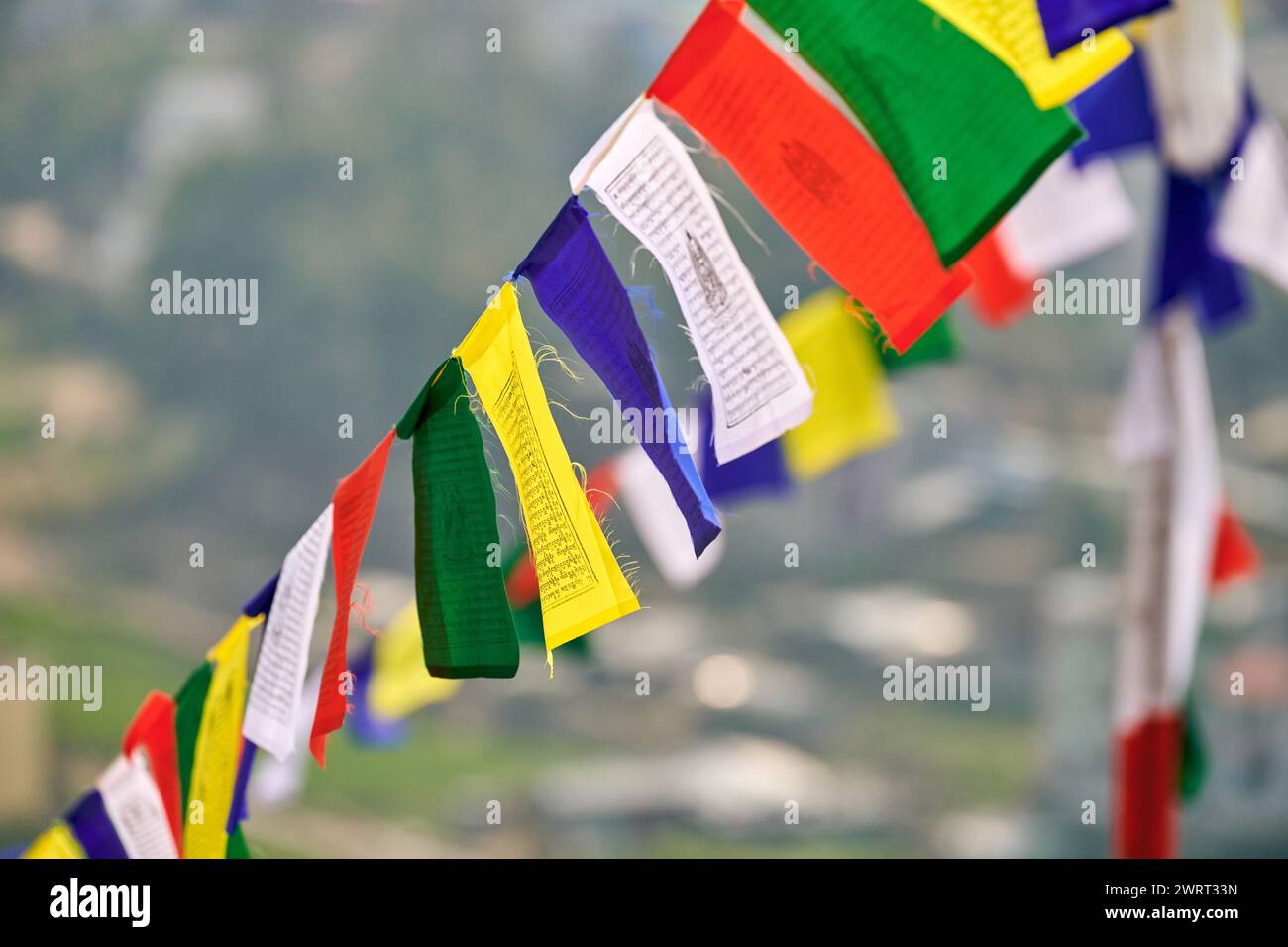 Colorful Tibetan prayer flags on blurred Kathmandu cityscape background ...