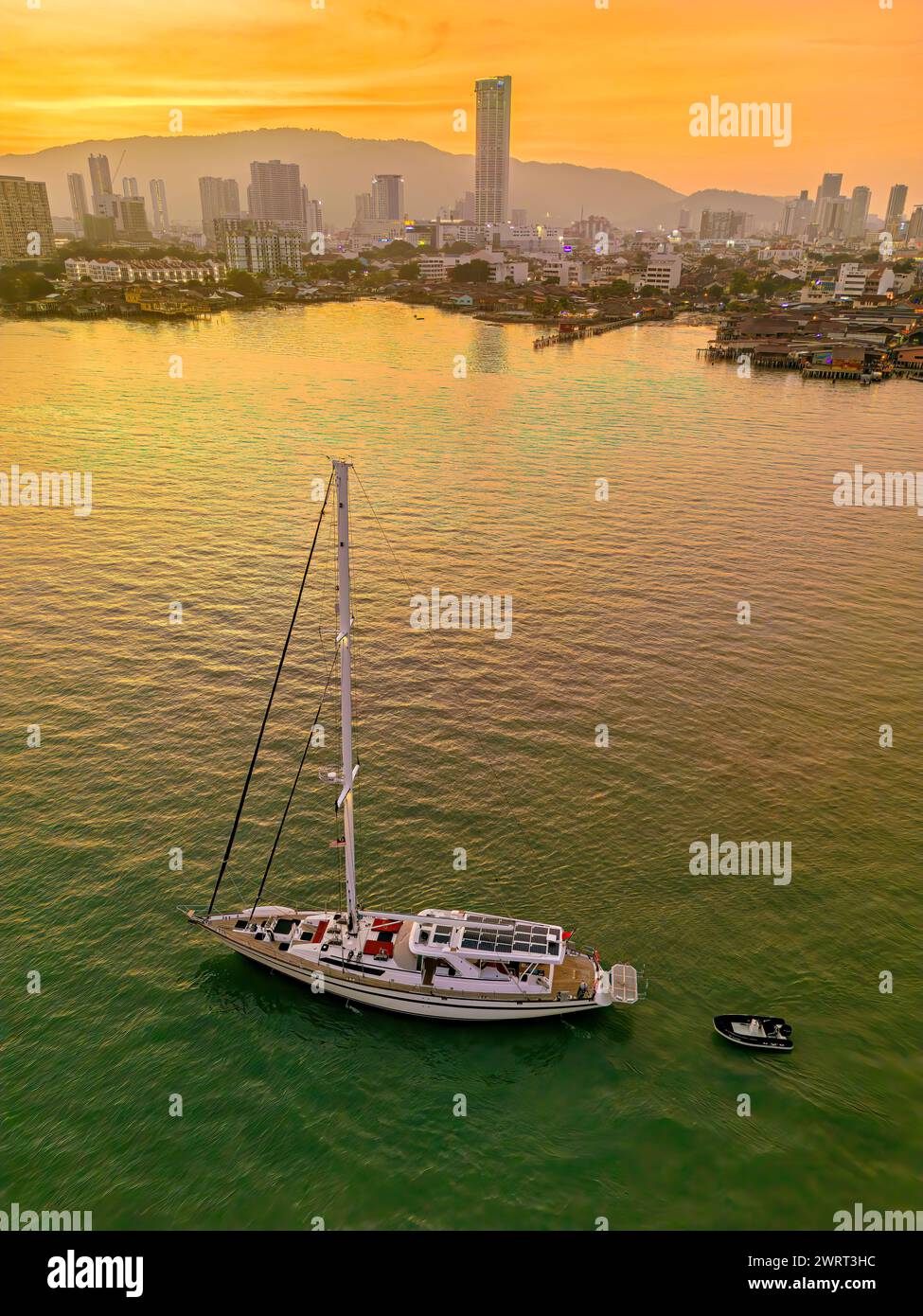 A sailboat berths at Penang Island with Komtar in the background Stock ...