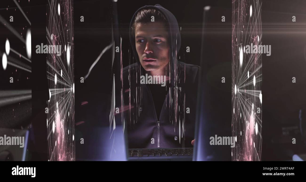 Hooded hacker manipulates digital connections on multiple screens Stock ...