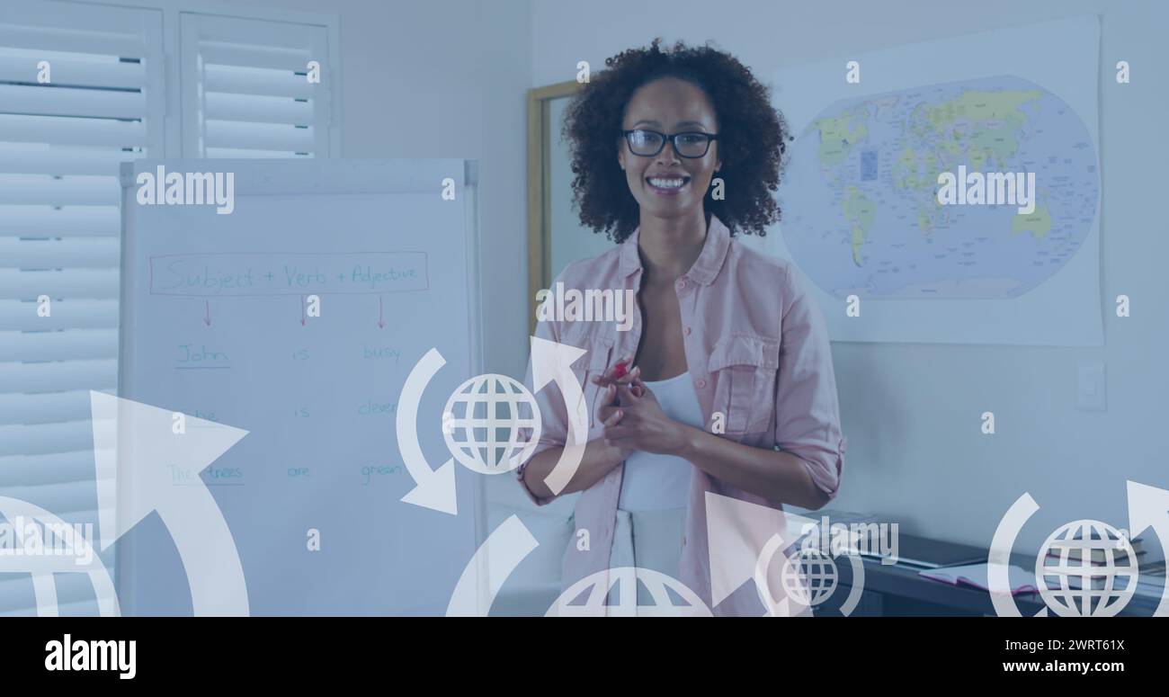 Image of globes and arrows floating over african american woman making ...