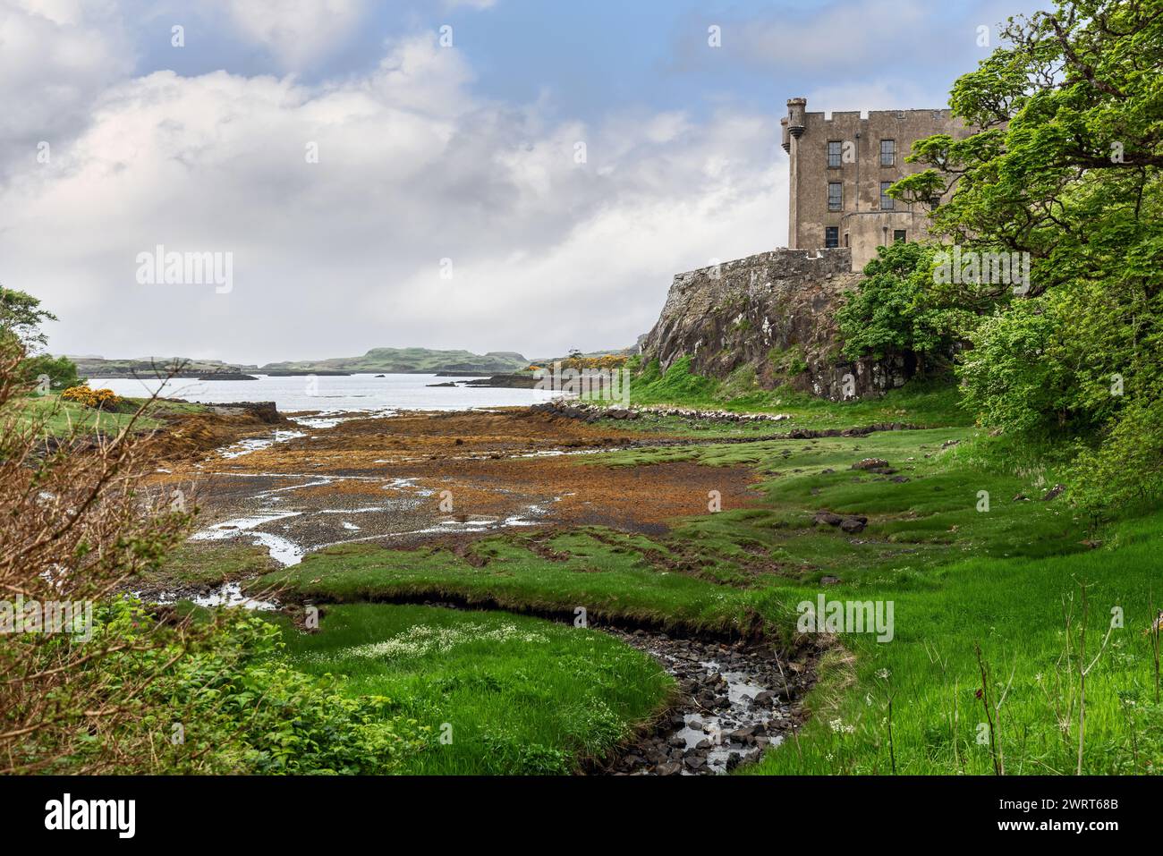 The historic Dunvegan Castle on the Isle of Skye, framed by vibrant ...