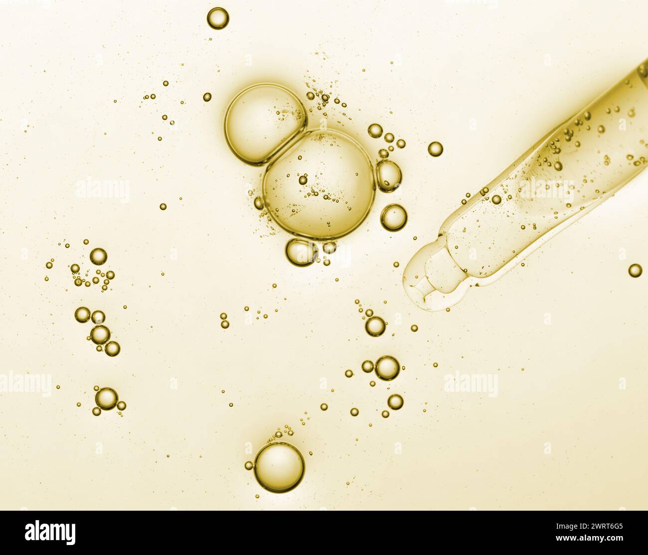 Pipette with yellow niacinamide serum oil sample swatch texture with ...