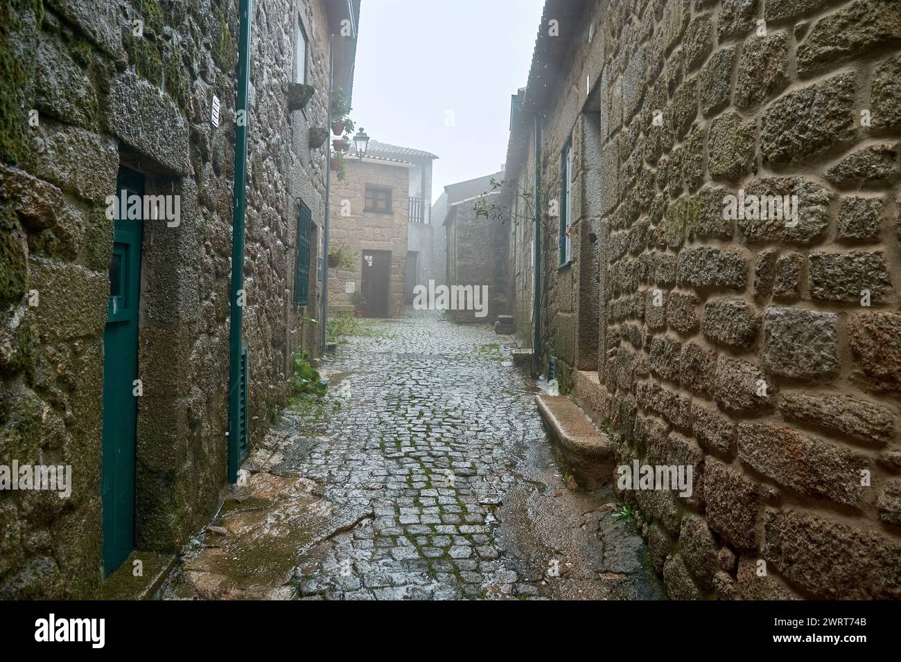 The streets of Monsanto in Portugal on a foggy and rainy day with its ...