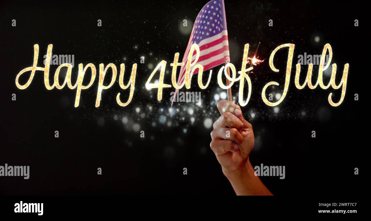 Image of 4th of july text over hand holding flag of united states of ...