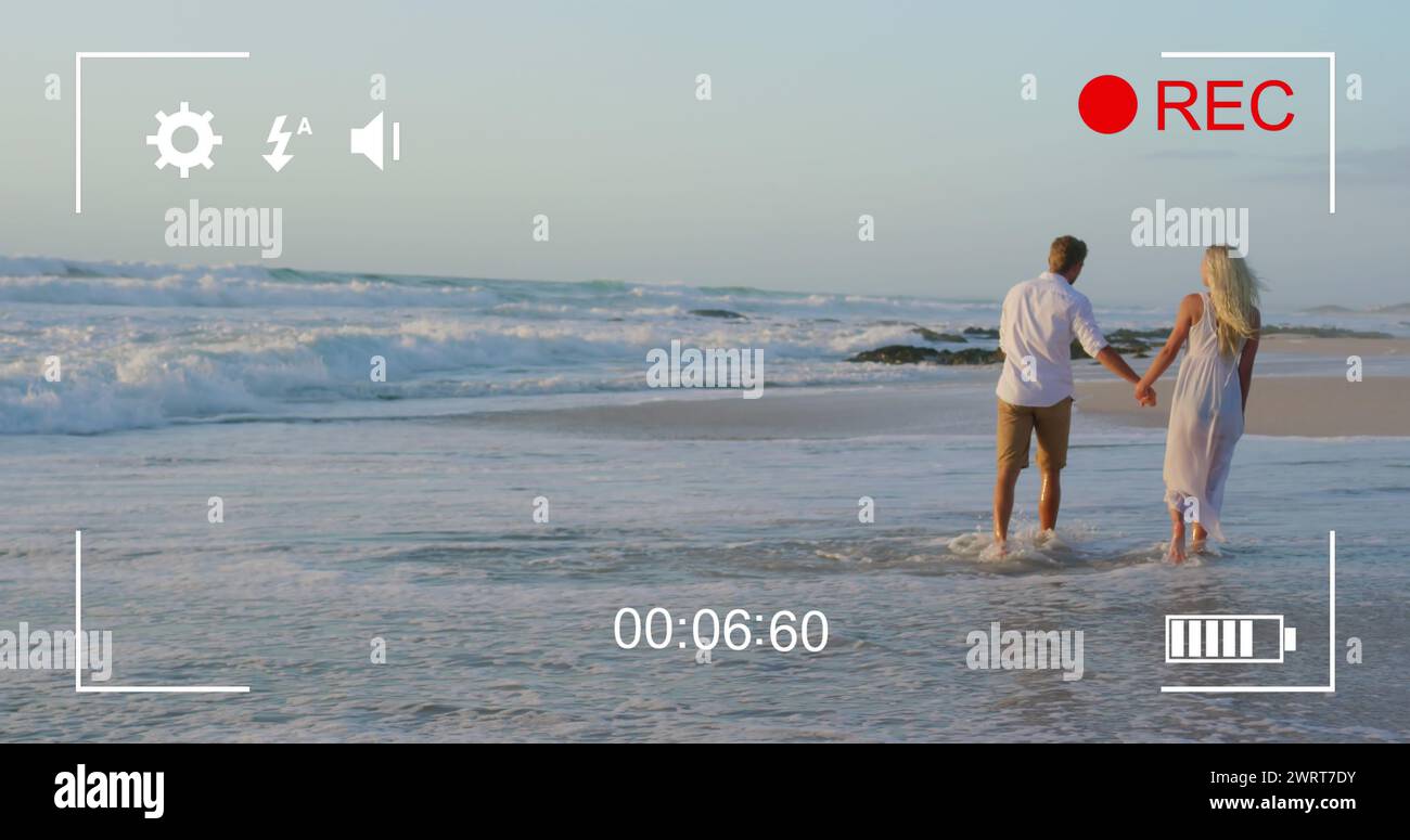 Couple holds hands on beach, viewed on a camera in 4k record mode Stock ...