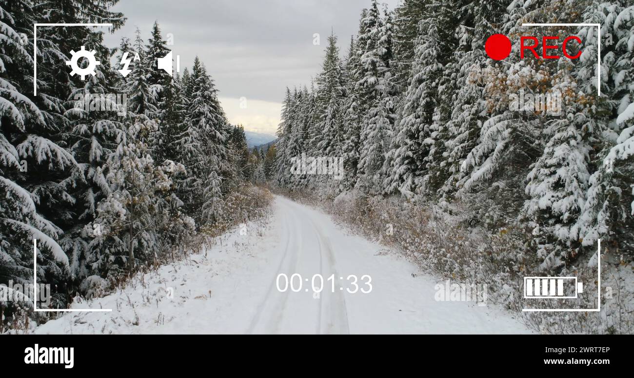 Digital camera records snowy forest scene in 4k with on-screen icons ...